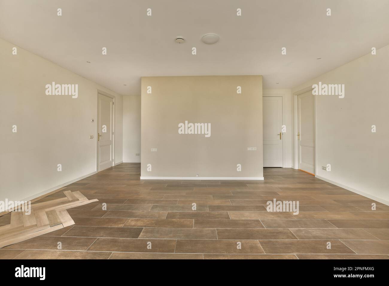 an empty room with white walls and wood flooring on the right, there is ...