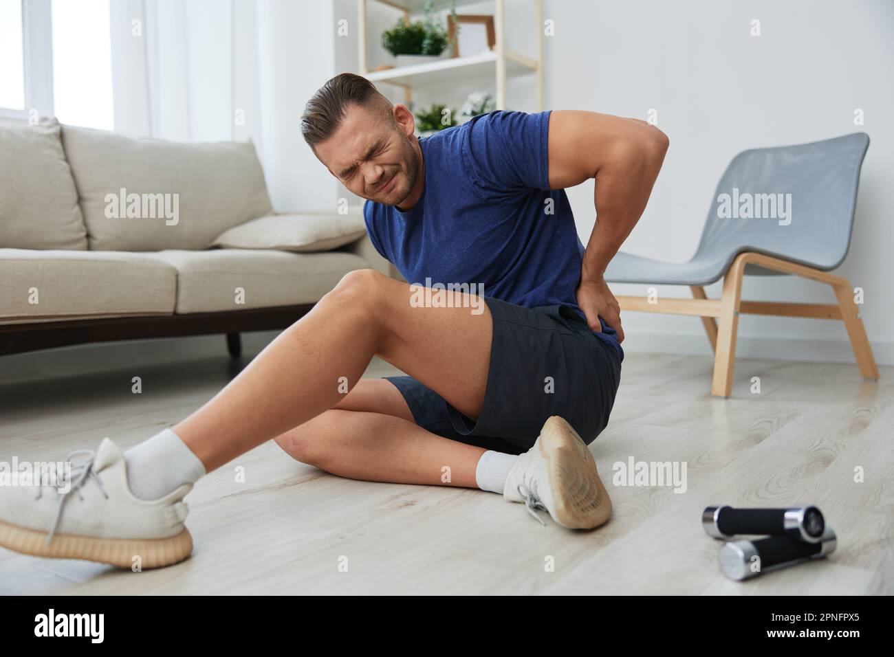 Man athlete pain and injury back arm and leg at home, sports injury ...