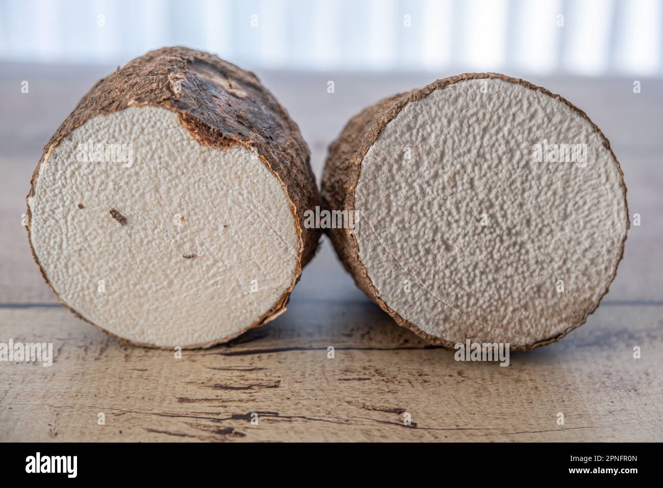 A tuber of yam cut in two ready for cooking Stock Photo - Alamy