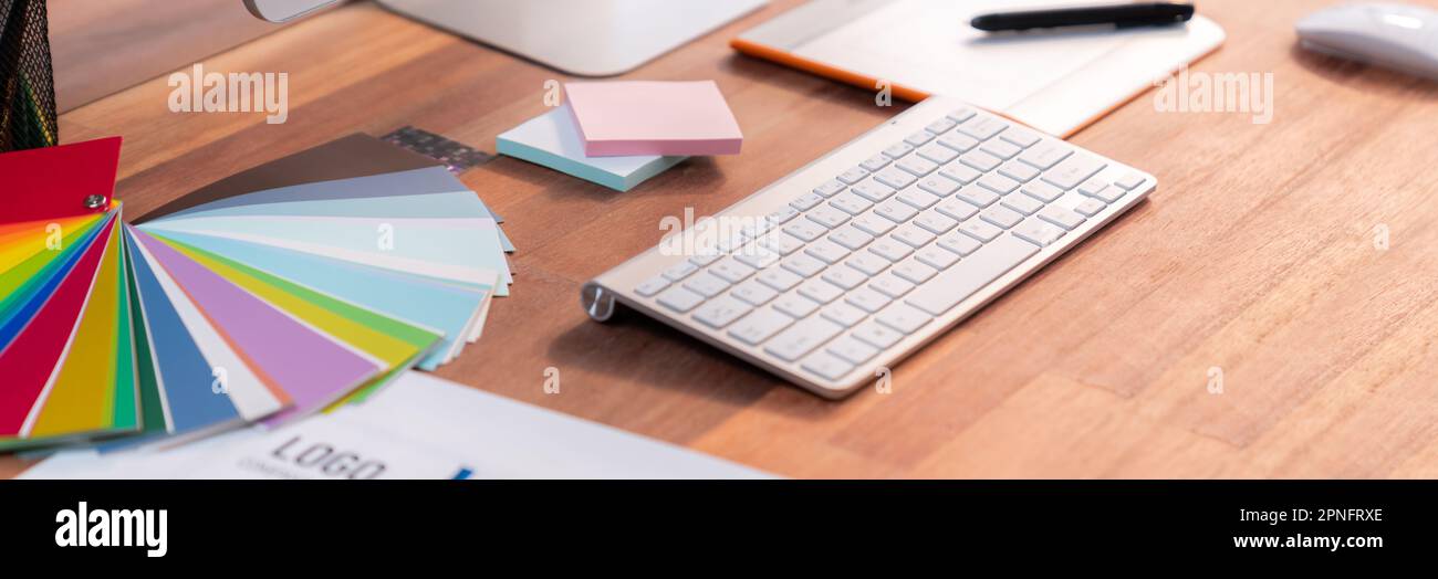 Graphic designer workspace feature color palette and laptop computer display for digital art ...