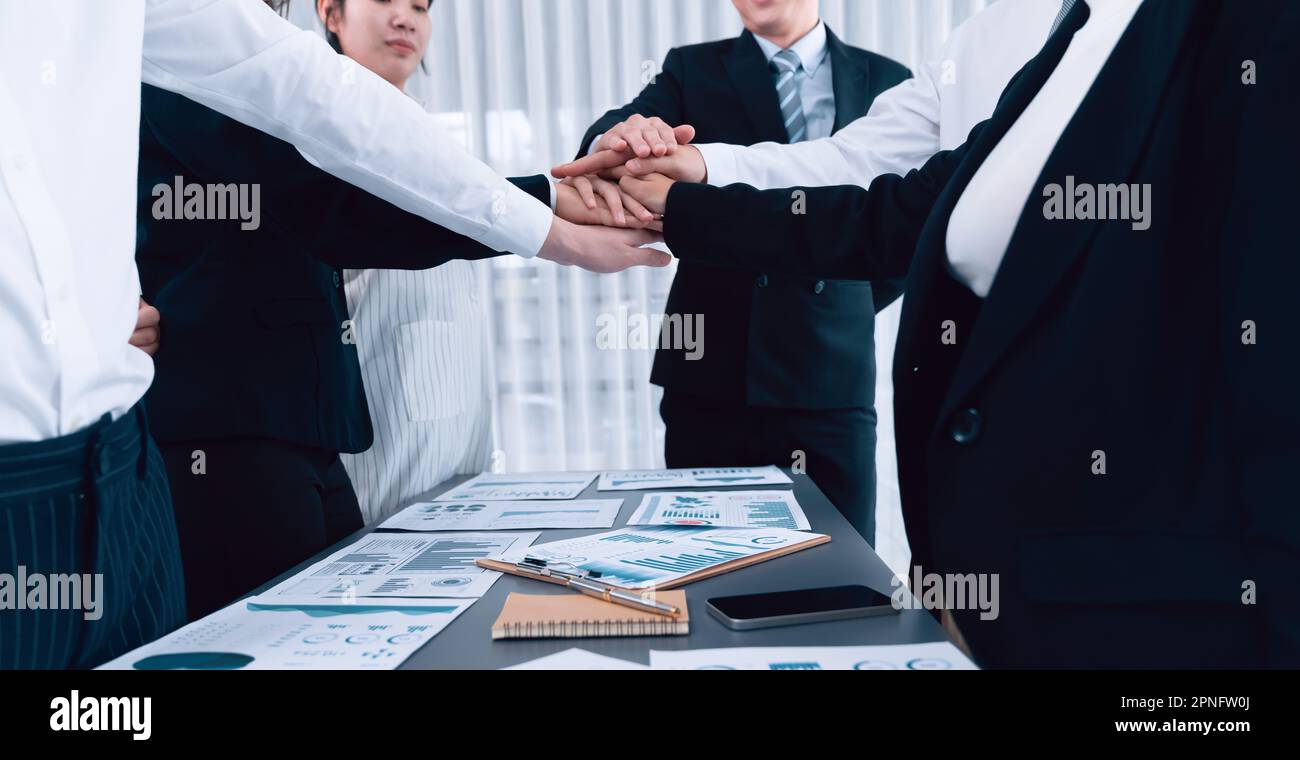 Closeup business team of suit-clad businessmen and women join hand ...