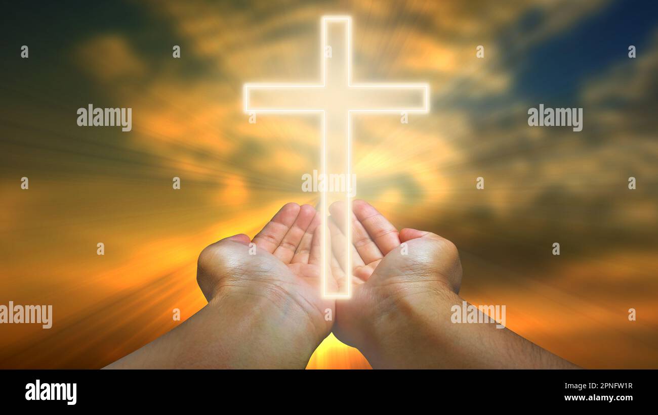 Hands holding a cross against blue sky with white clouds and sun Stock ...