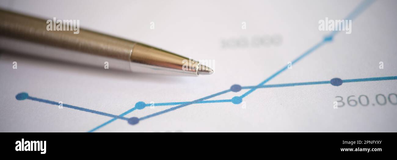 Pen on document with statistics data, graph and chart Stock Photo - Alamy
