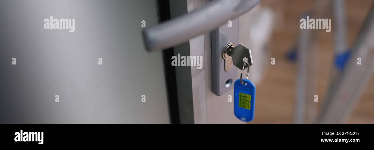 Open door with steel lock and keys with number tag Stock Photo - Alamy