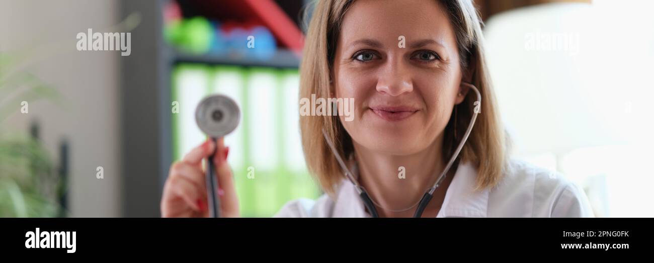 Happy smiling female practitioner showing medical stethoscope Stock ...