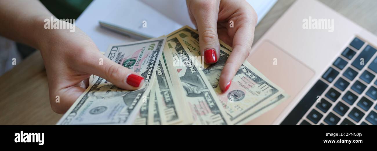 Female holding cash in hand and counting banknotes Stock Photo - Alamy