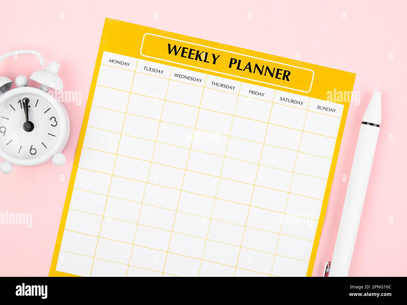 Blank weekly plan notice block with alarm clock with pink on pink color ...