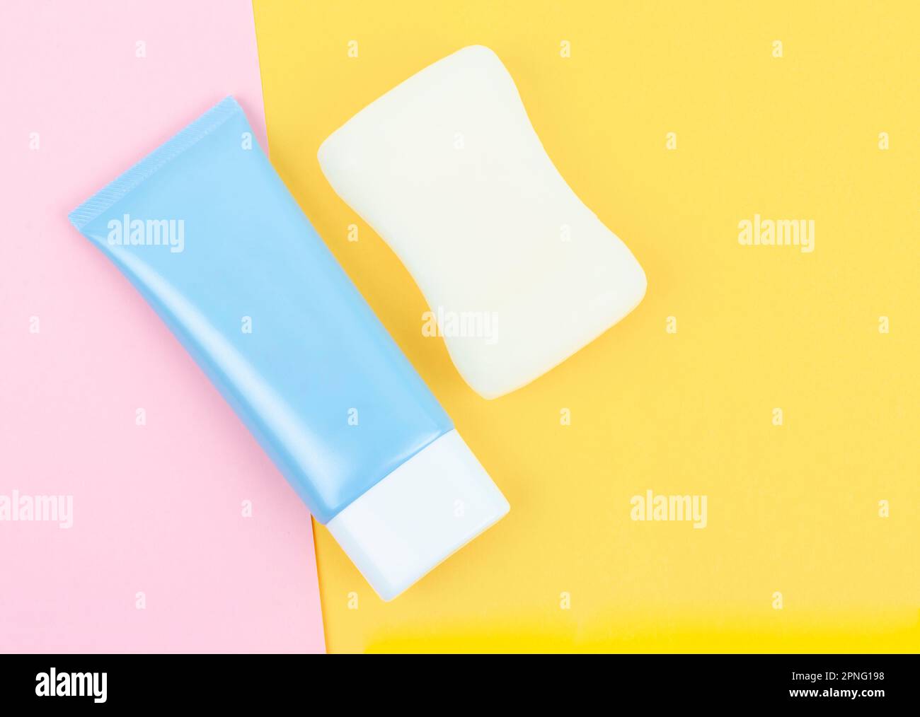 Top view blue squeeze bottle plastic tube and herb soap bar on ...