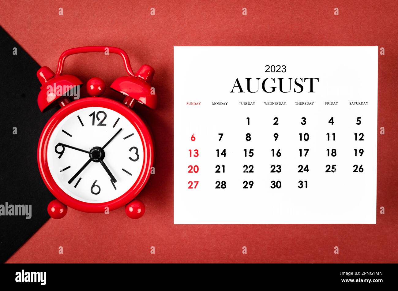 August 2023 Monthly calendar year with alarm clock on red and black ...