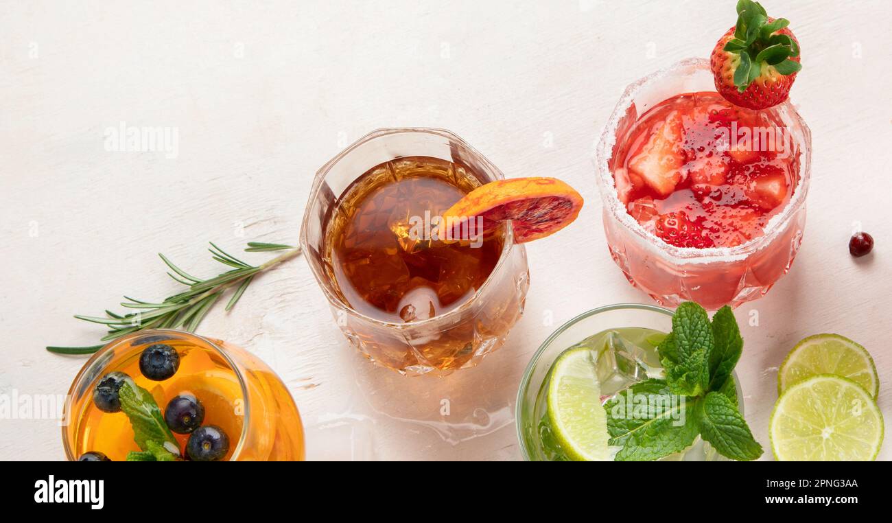 Different delicious cocktails on table. Alcoholic coctail with fruit ...