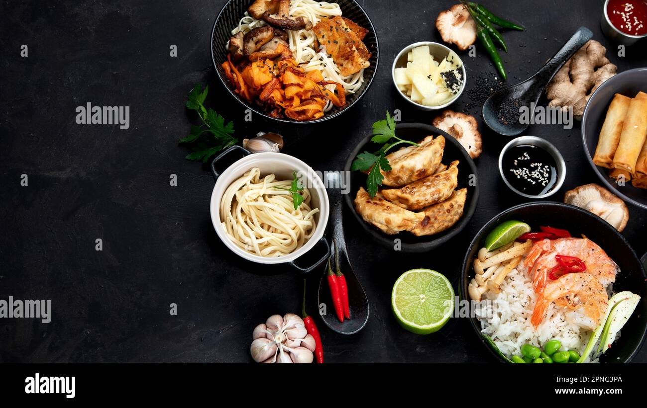 Various asian meals dishes on black background , top view. Asian food ...