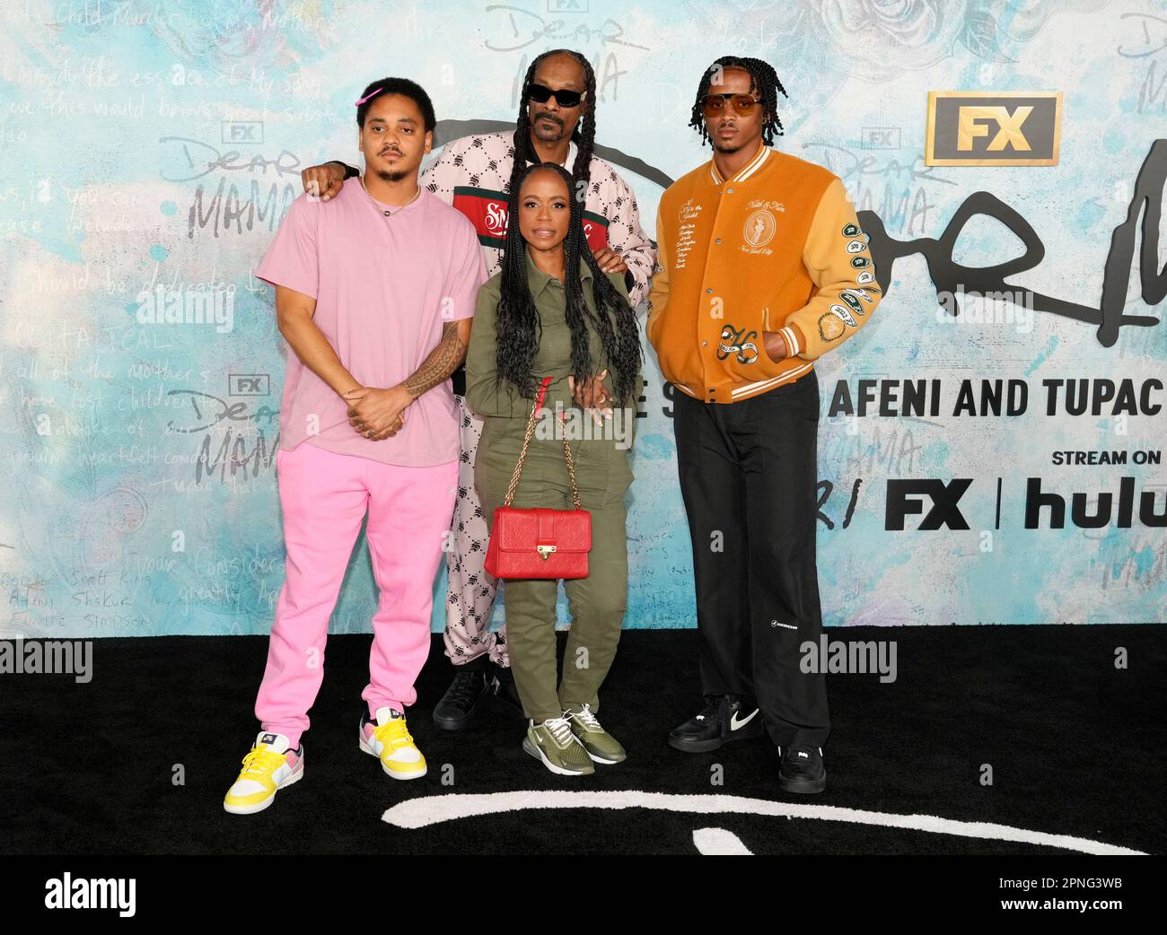 Rapper Snoop Dogg, top center, poses with his wife Shante Broadus and ...