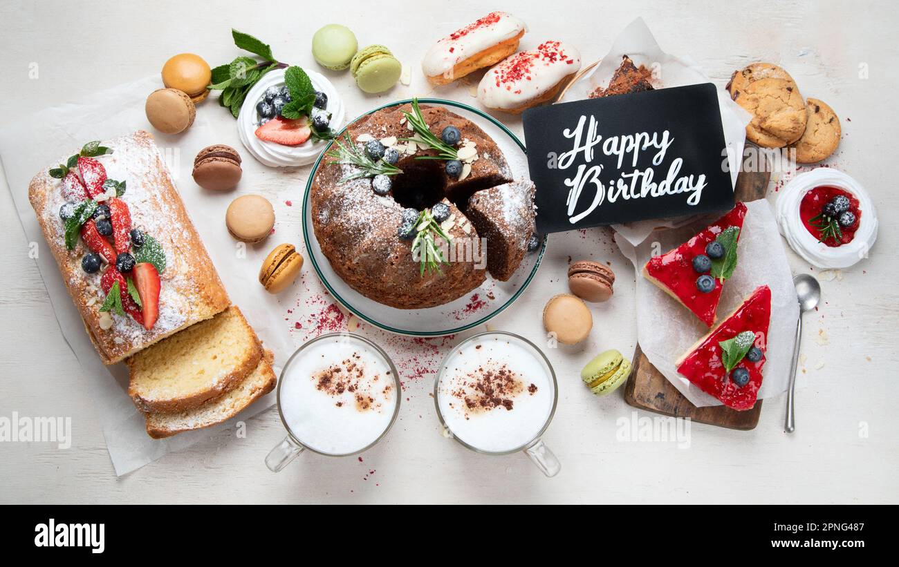 Dessert table with various of bundt cakes, pieces of cakes, sweets ...