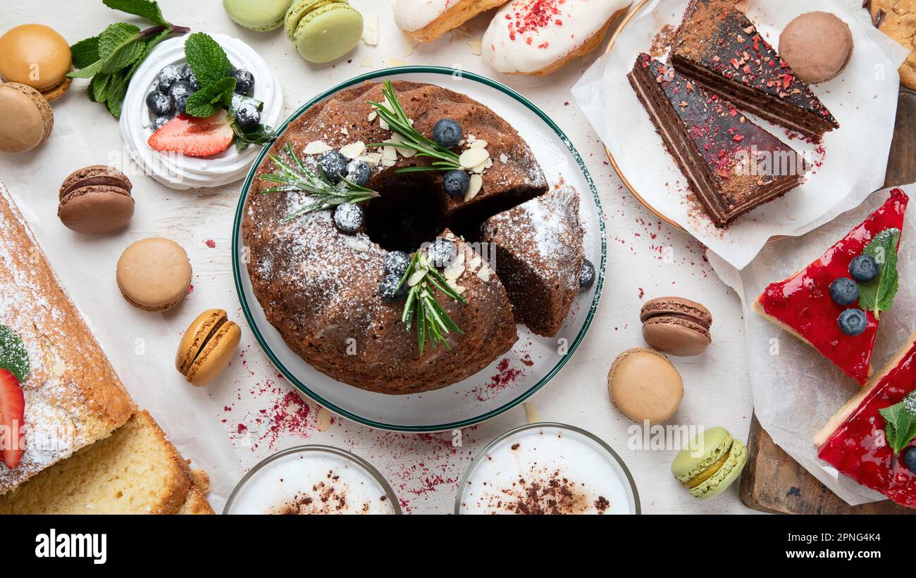 Dessert table with various of bundt cakes, pieces of cakes, sweets ...