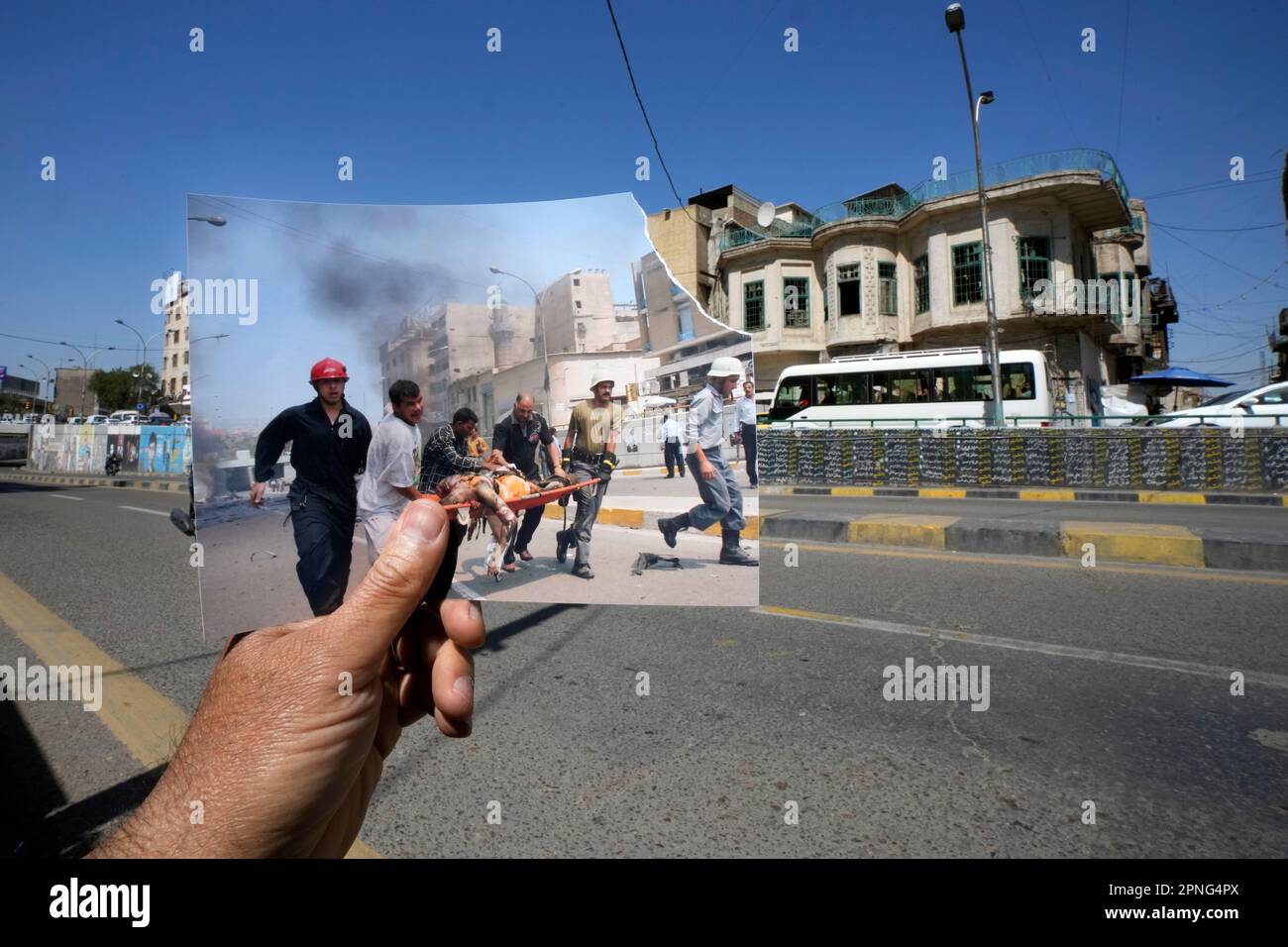 A photograph of Iraqi firemen evacuating an injured person after a car ...