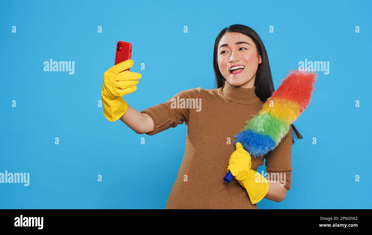 Maid holding feather duster hi-res stock photography and images - Alamy
