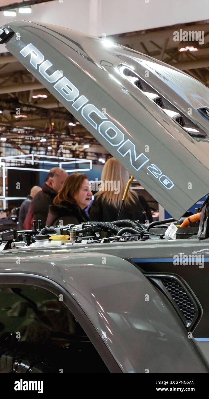Close up view of grey Rubicon Jeep car on display. Crowds looking at ...