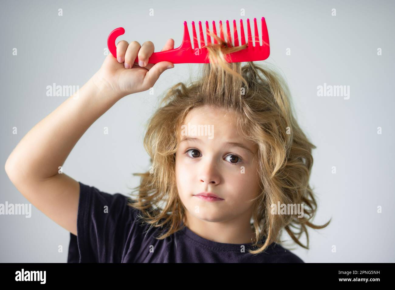 Haircare and kids hair styling. Kid boy makes face expressions, combing ...