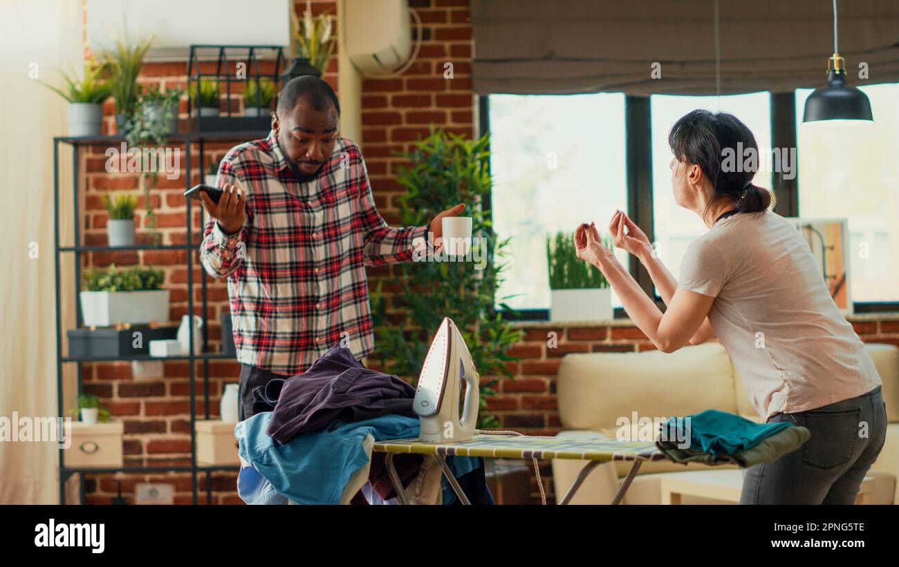 Modern person ironing washed clothes feeling depressed about doing ...