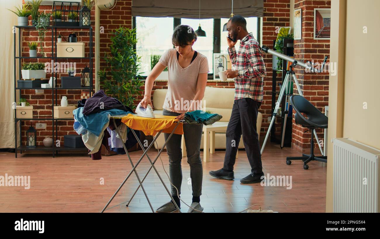 Angry girlfriend throwing shirt at boyfriend, being frustrated and ...