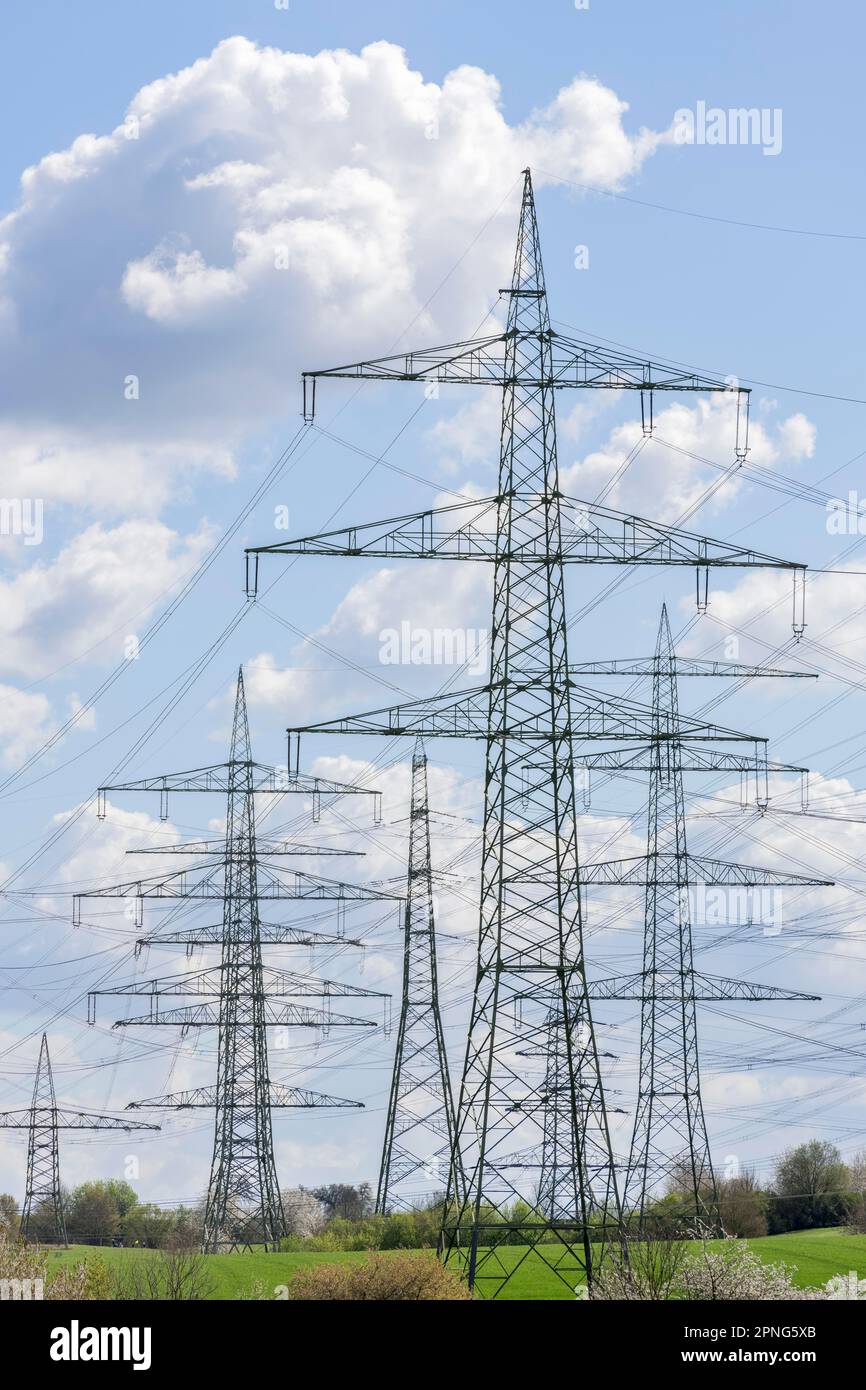 High-voltage pylons in front of cloudy sky, overhead power lines, Baden ...