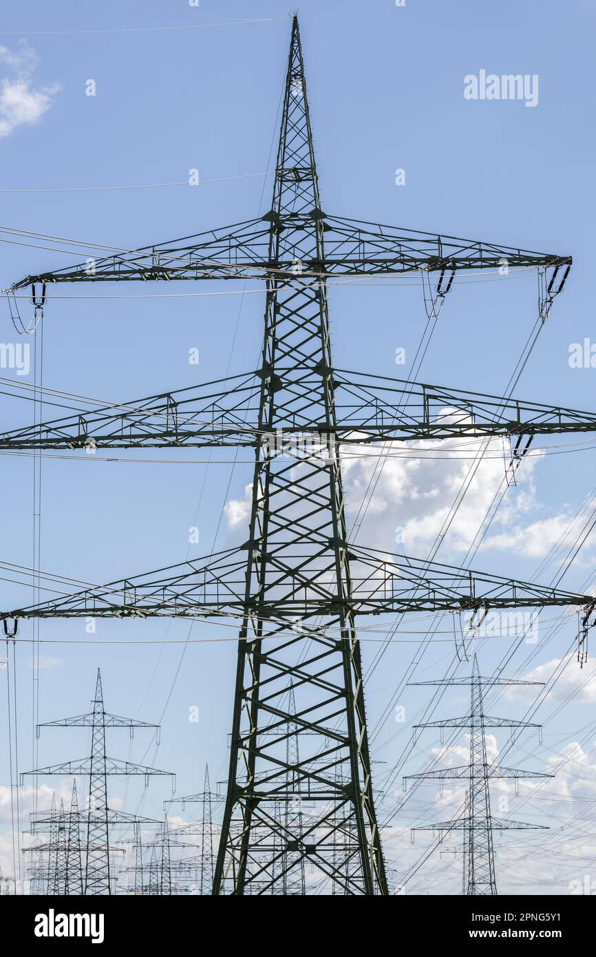 High-voltage pylons in front of cloudy sky, overhead power lines, Baden ...