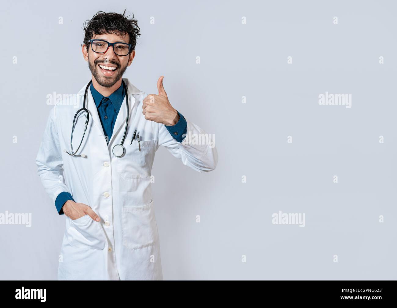 Smiling doctor giving thumb up isolated. Handsome doctor with thumb up ...