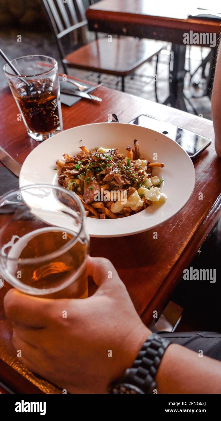 Freshly cooked Canadian dish putin with chicken and cheese. French ...