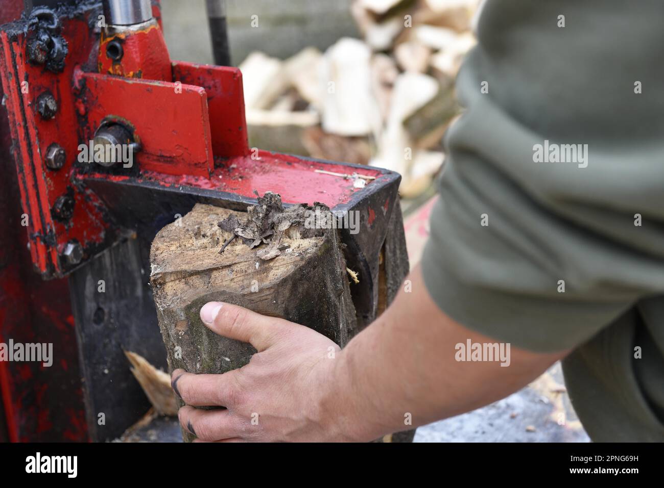 Worker making firewood with a log splitter, Germany Stock Photo - Alamy