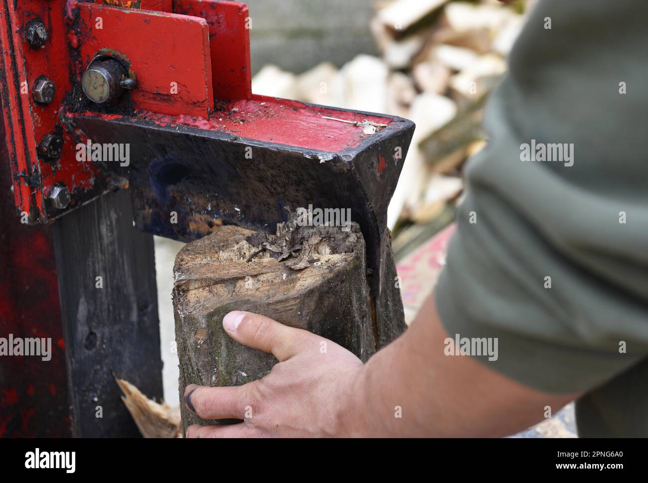 Worker making firewood with a log splitter, Germany Stock Photo - Alamy