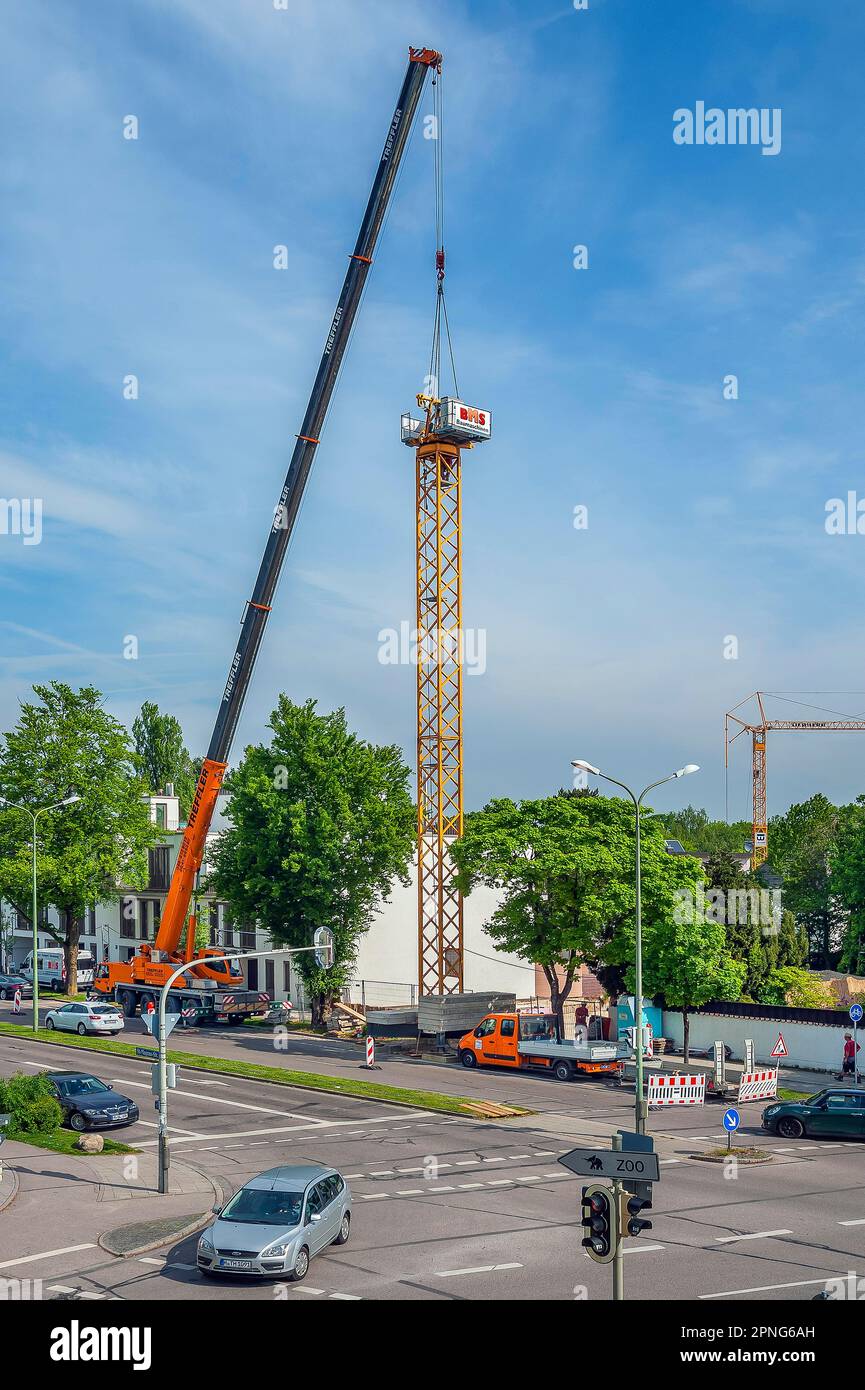 A construction crane is erected with a truck-mounted crane, Harlaching ...