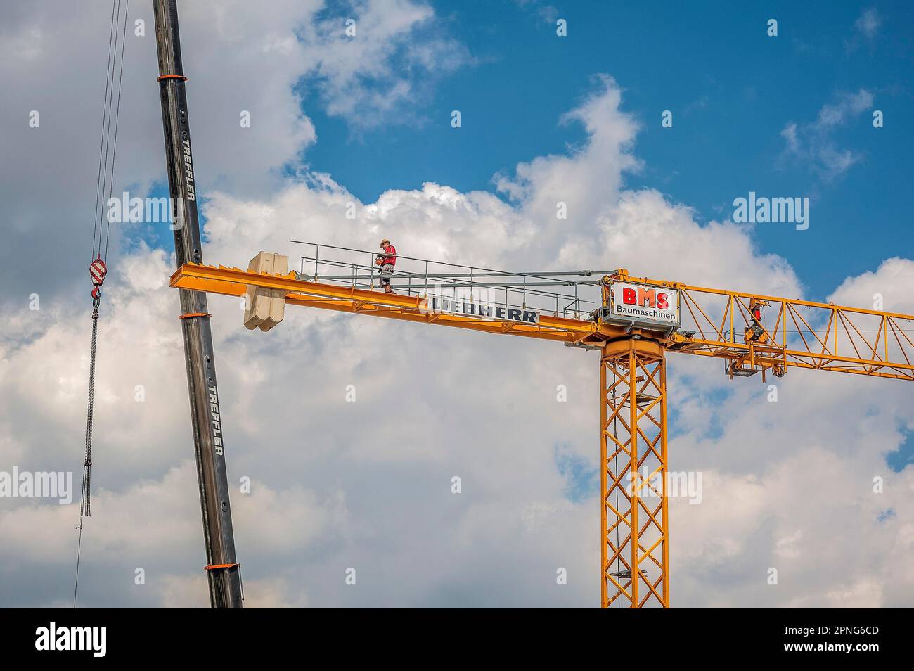 A construction crane is erected with a truck-mounted crane, Harlaching ...