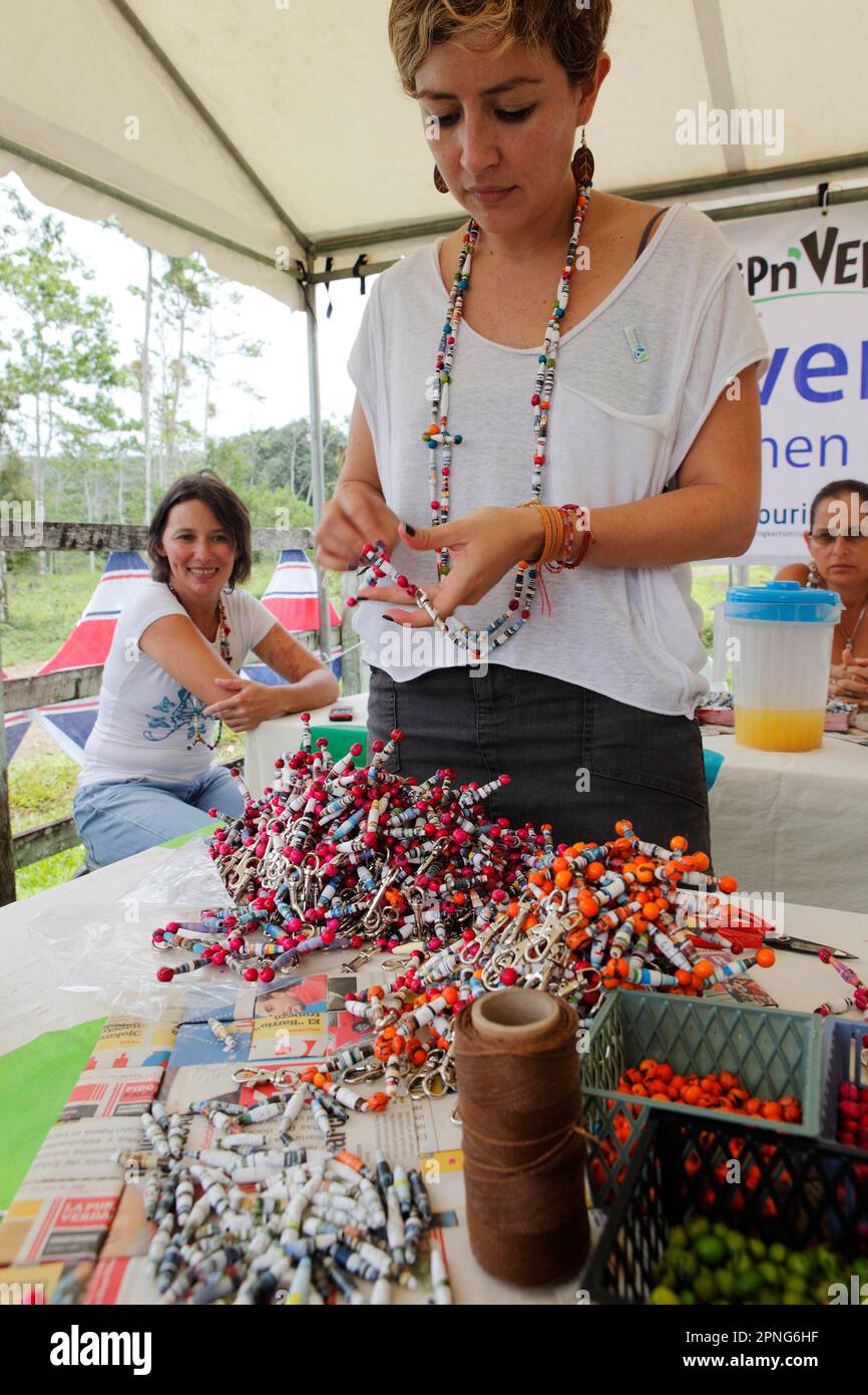 Costa Rican woman checks key rings made from old newspaper, Women ...