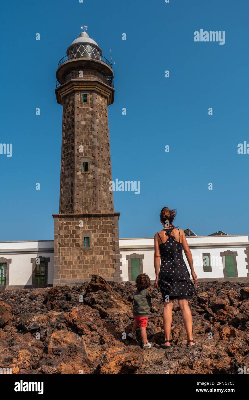 Mother and son visiting on vacation at the beautiful lighthouse of ...