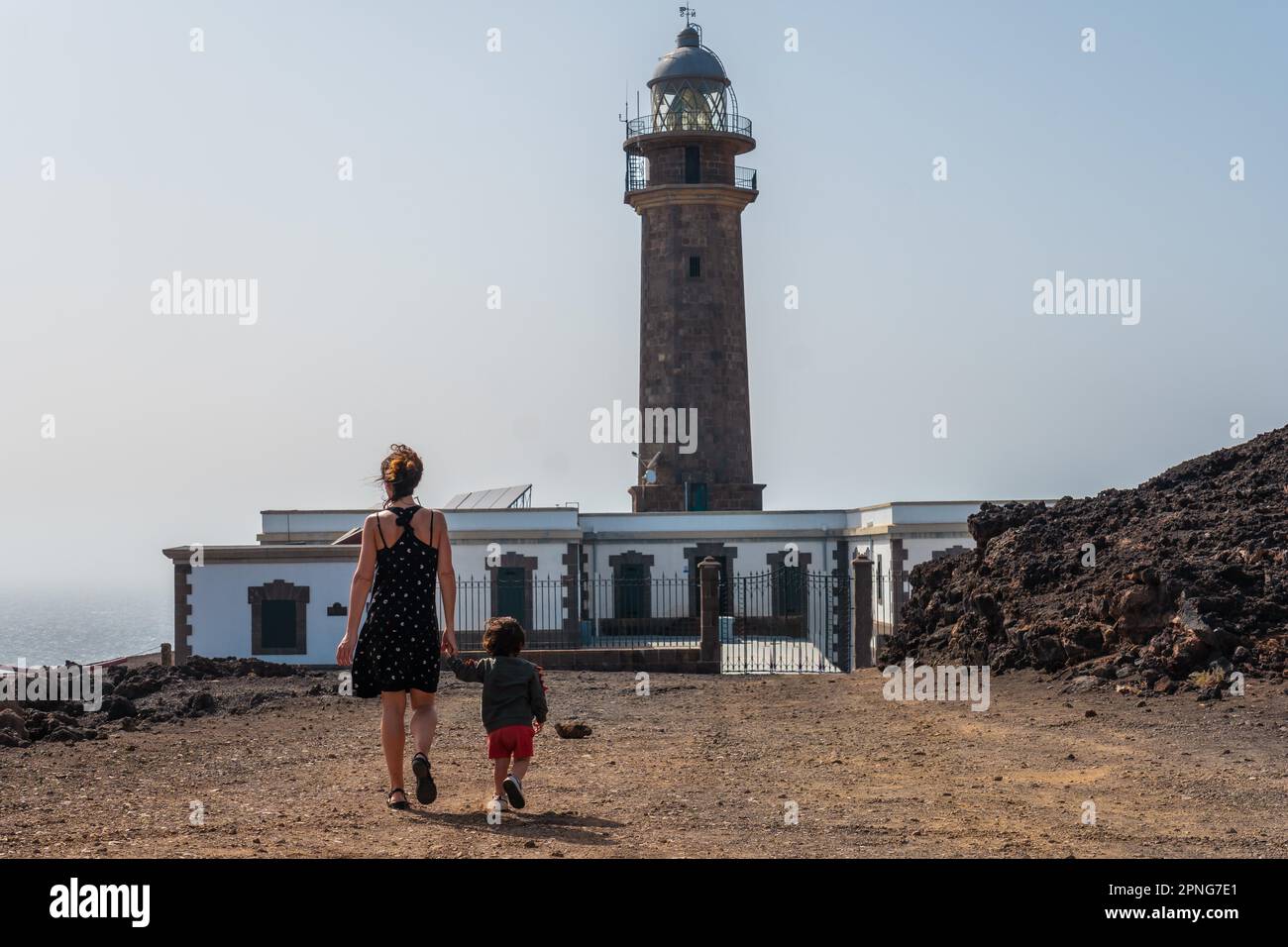 Mother and son visiting the beautiful Orchilla lighthouse on El Hierro ...