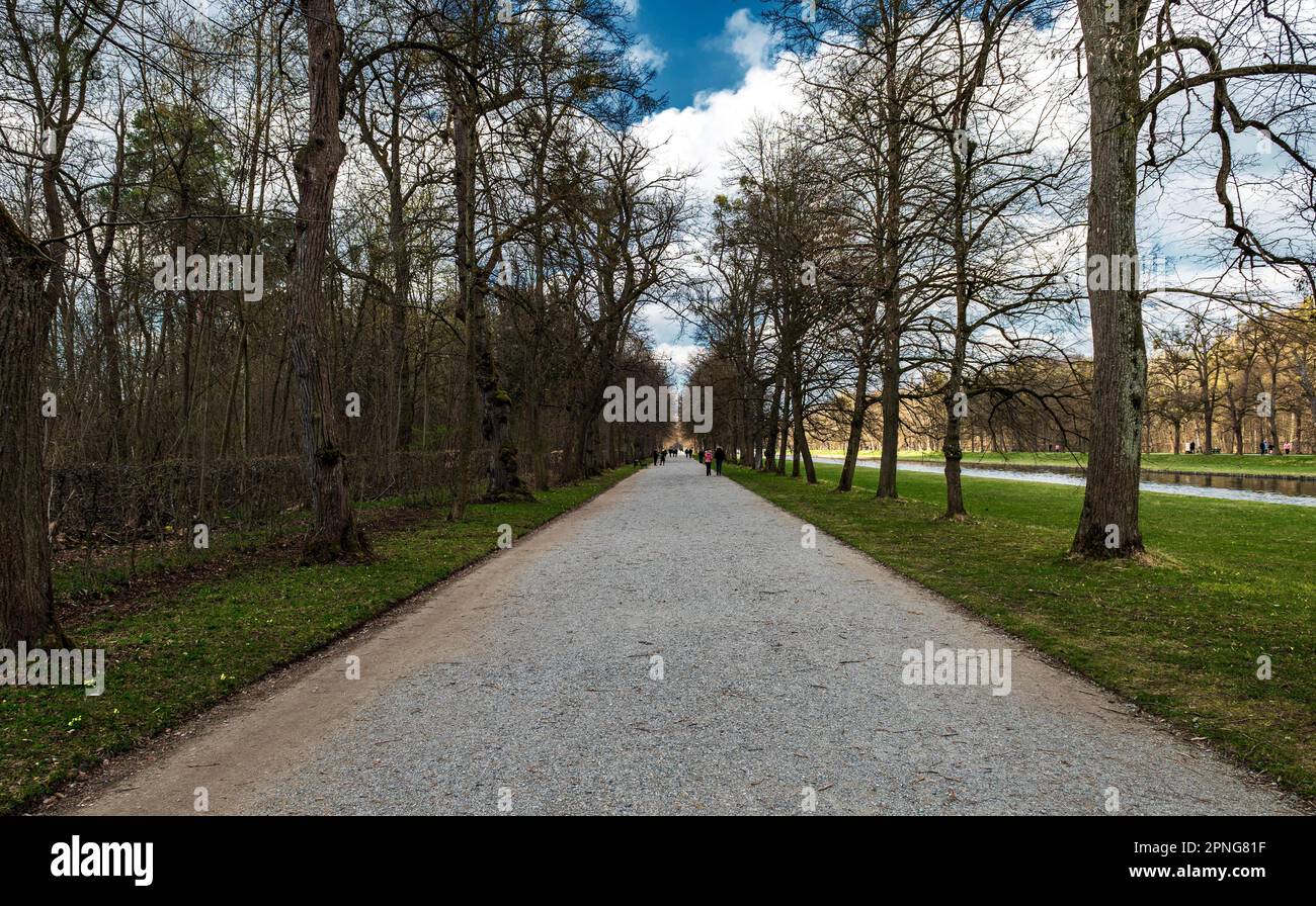 Avenue next to the palace garden canal in the park of Nymphenburg ...