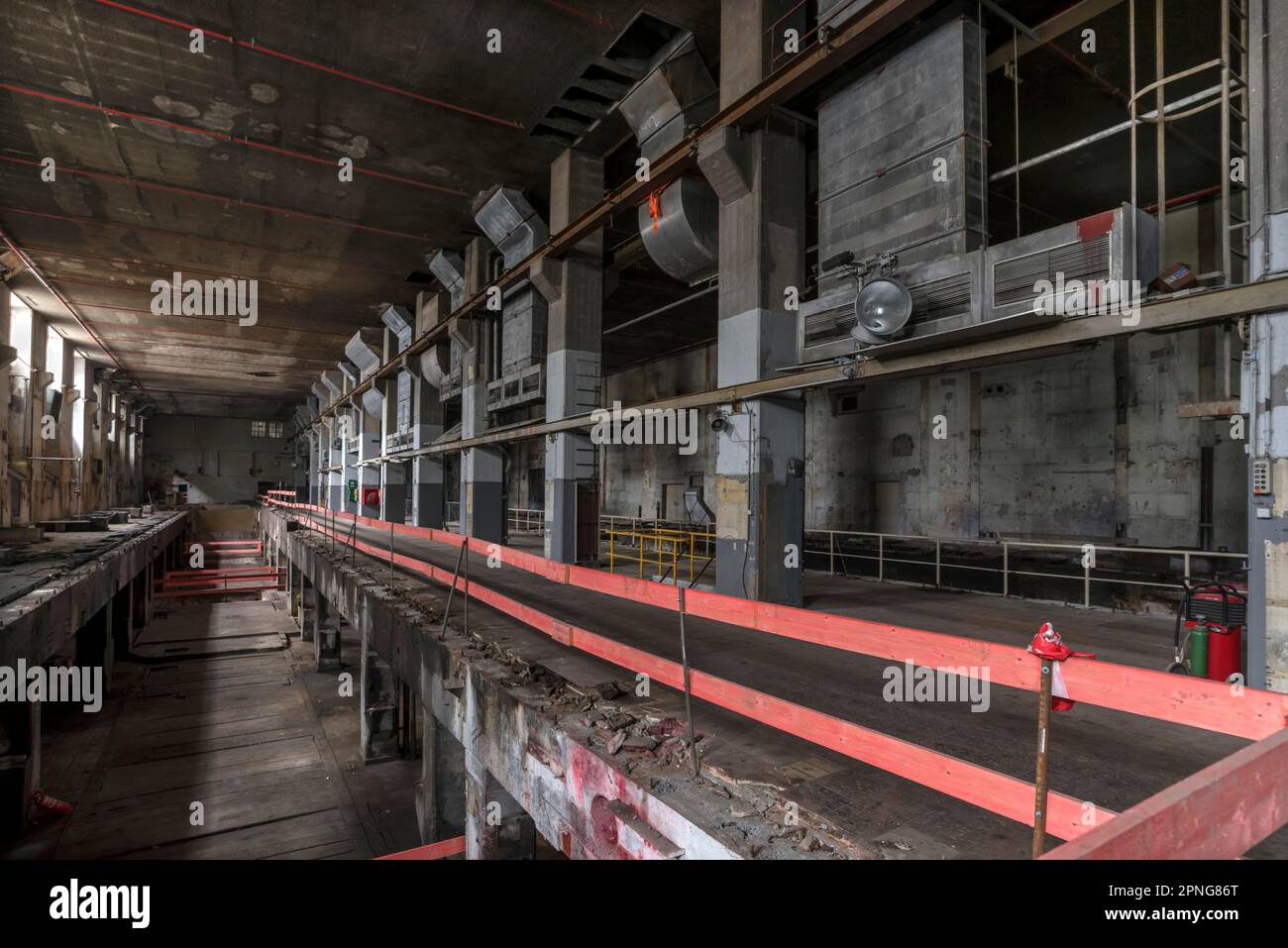 Security barrier in the empty production halls of a former paper ...