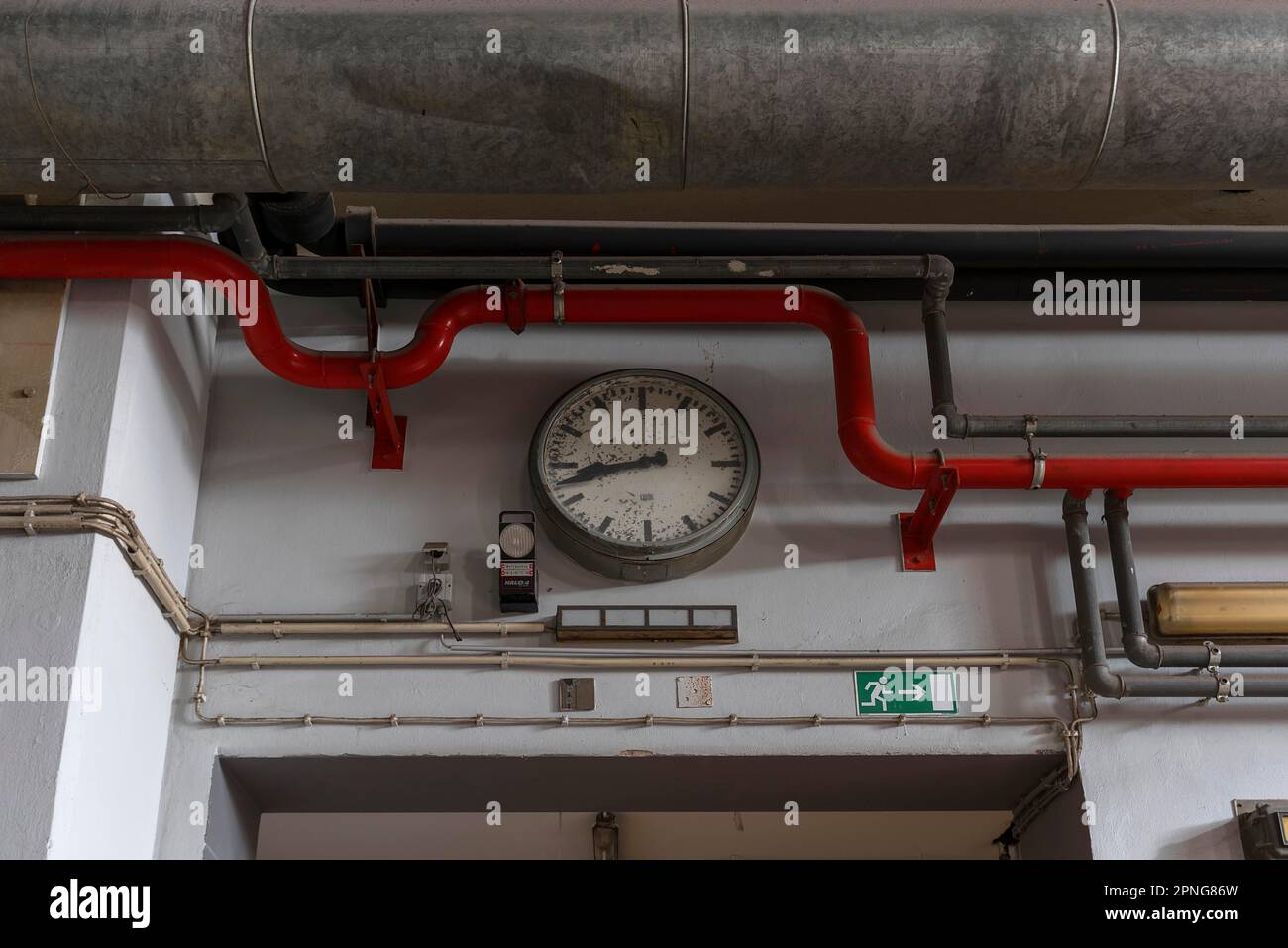Wall clock in a production hall in a former paper factory, Lost Place ...