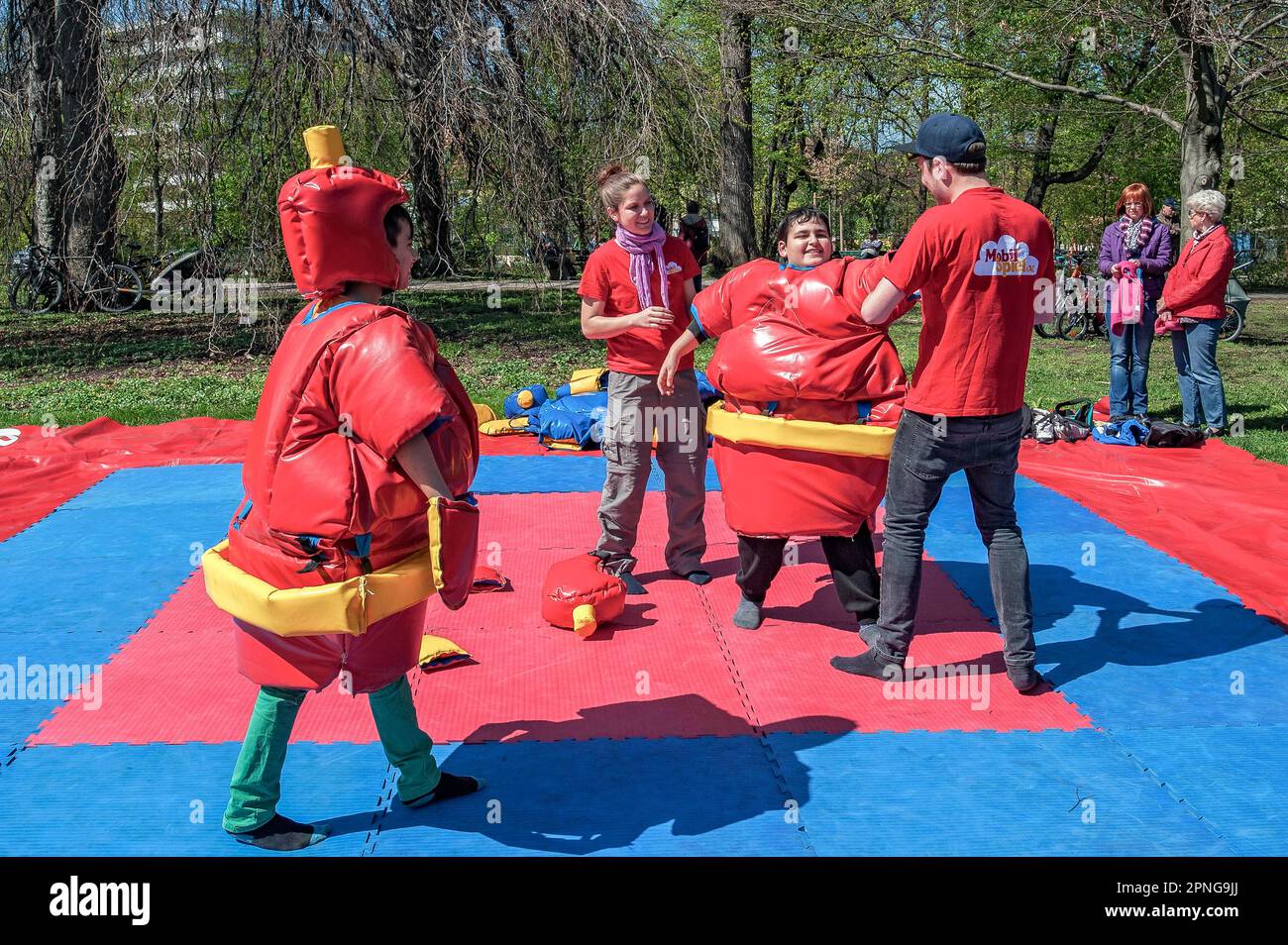 Children playing as sumo wrestlers in springtime Luitpoldpark, Munich ...