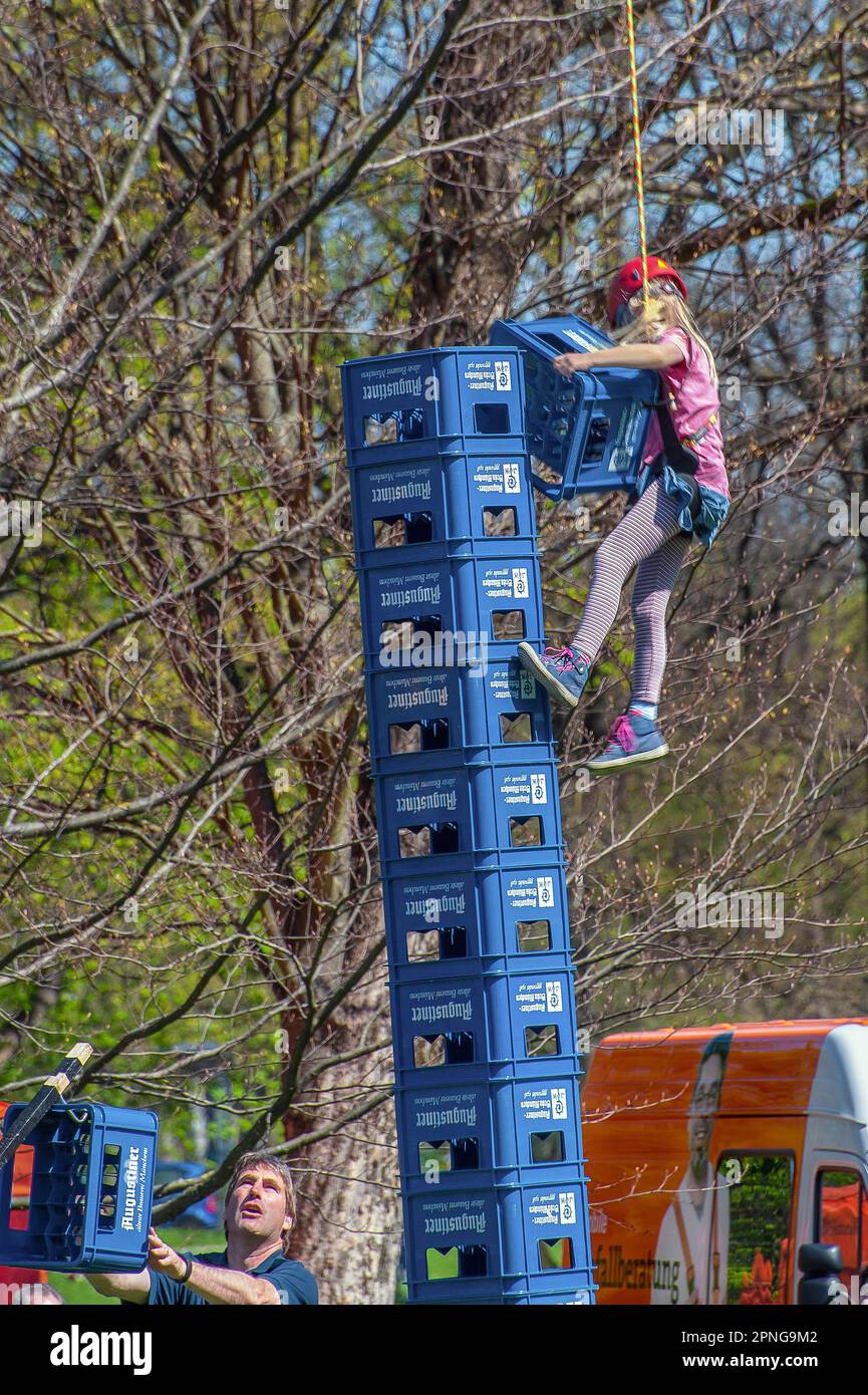 Child secured by rope falls while building tower out of beer crates ...