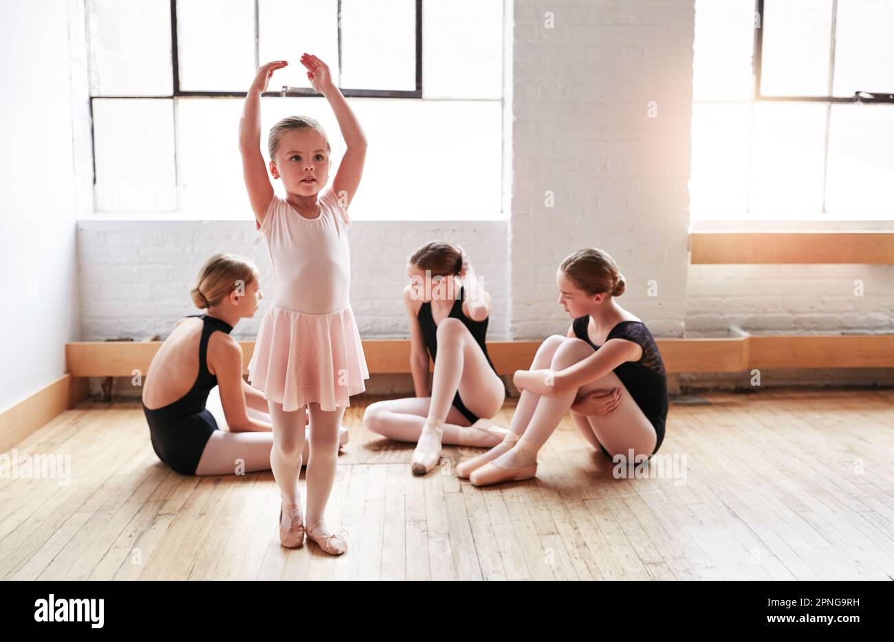 Born to be a ballerina. an adorable little girl learning ballet with a ...