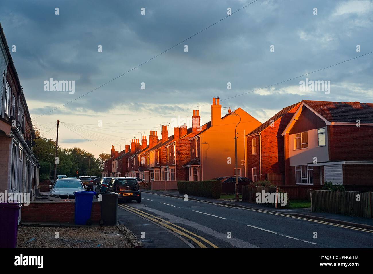 dramatic view of terraced houses catching the sunlight at sundown on a ...