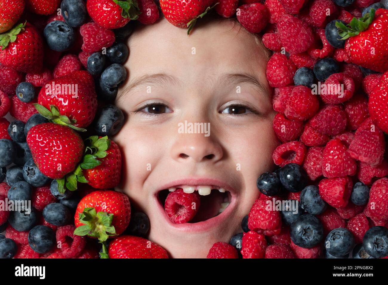 Fruits set. Child face with berries mix of strawberry, blueberry ...