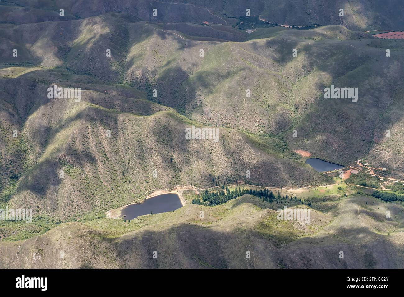 aerial landscape, from a glider, with little lakes among green slopes ...