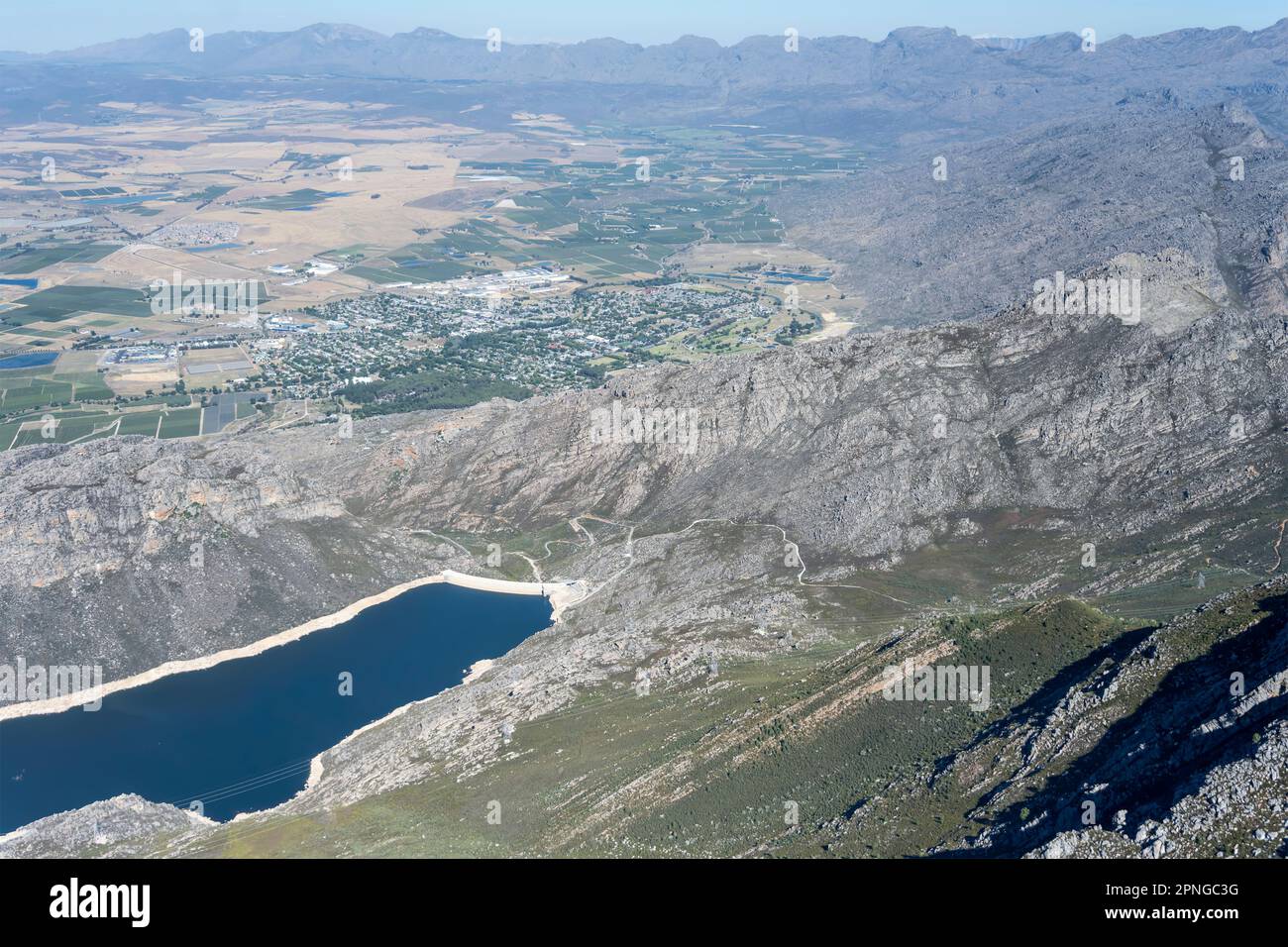 aerial landscape, from a glider, with lake and dam among rocky slopes ...