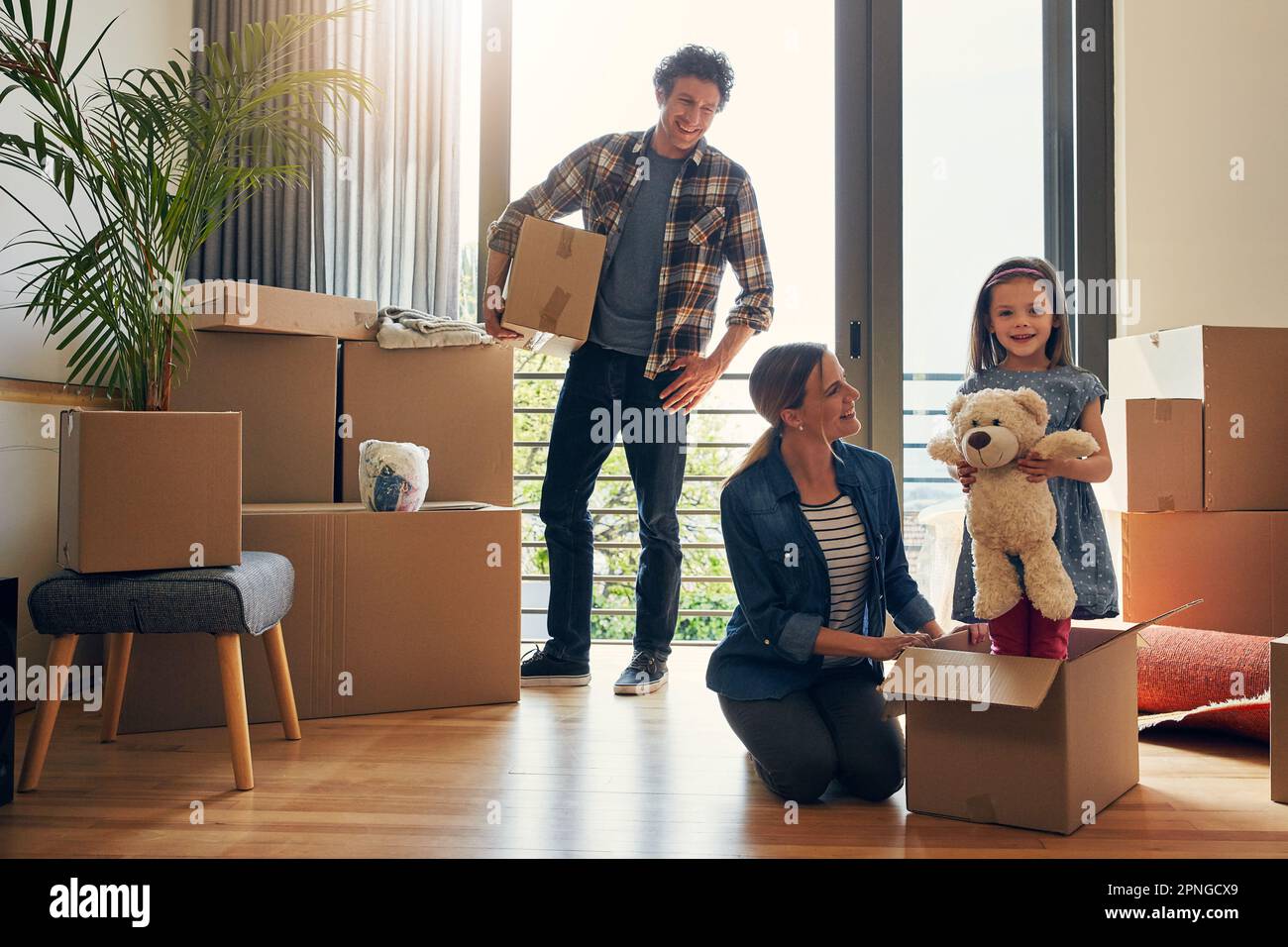 Everybody helping out on moving day. Portrait of a cheerful loving ...