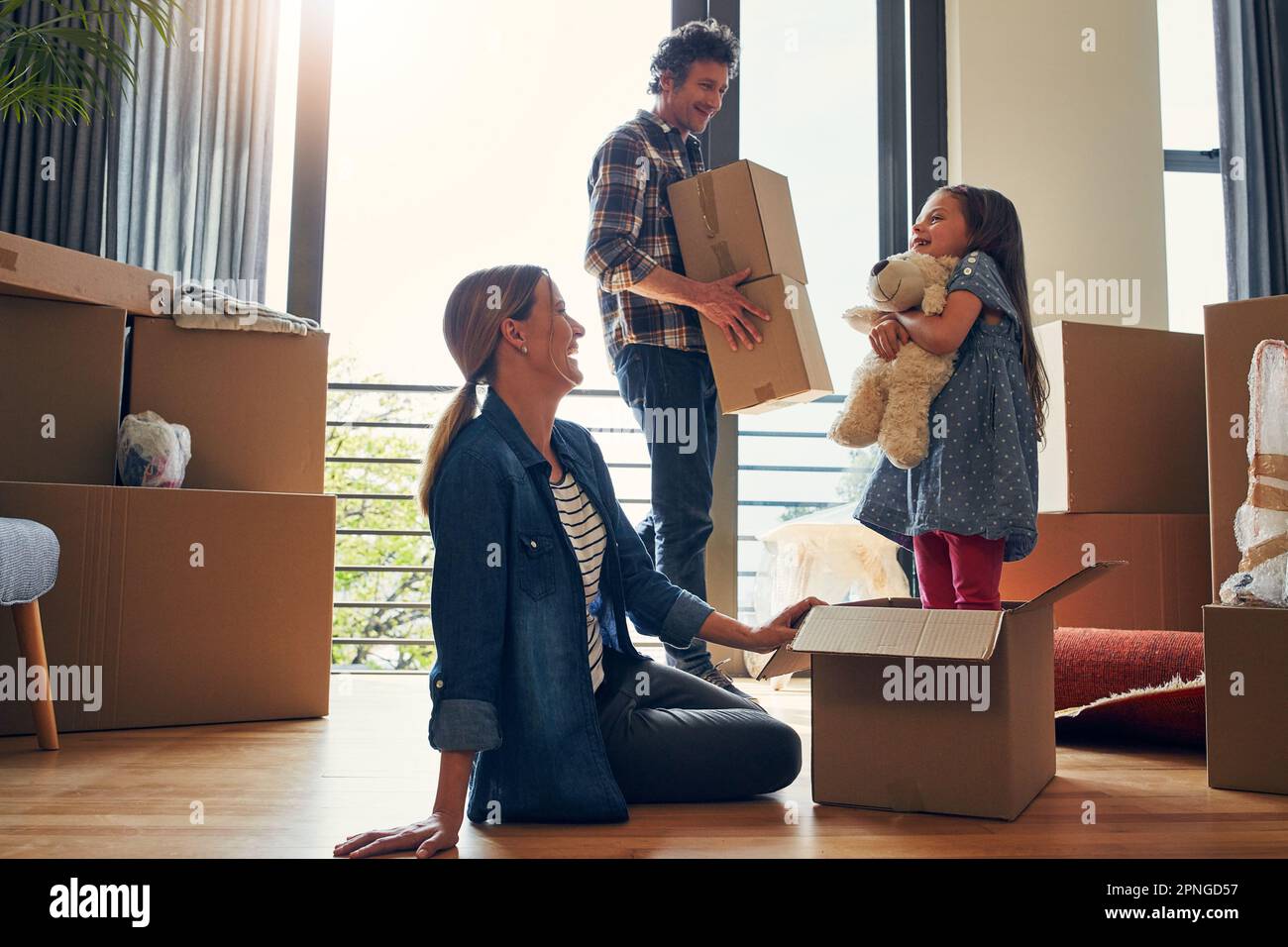 Somebody seems to like the new home. a cheerful loving family packing ...