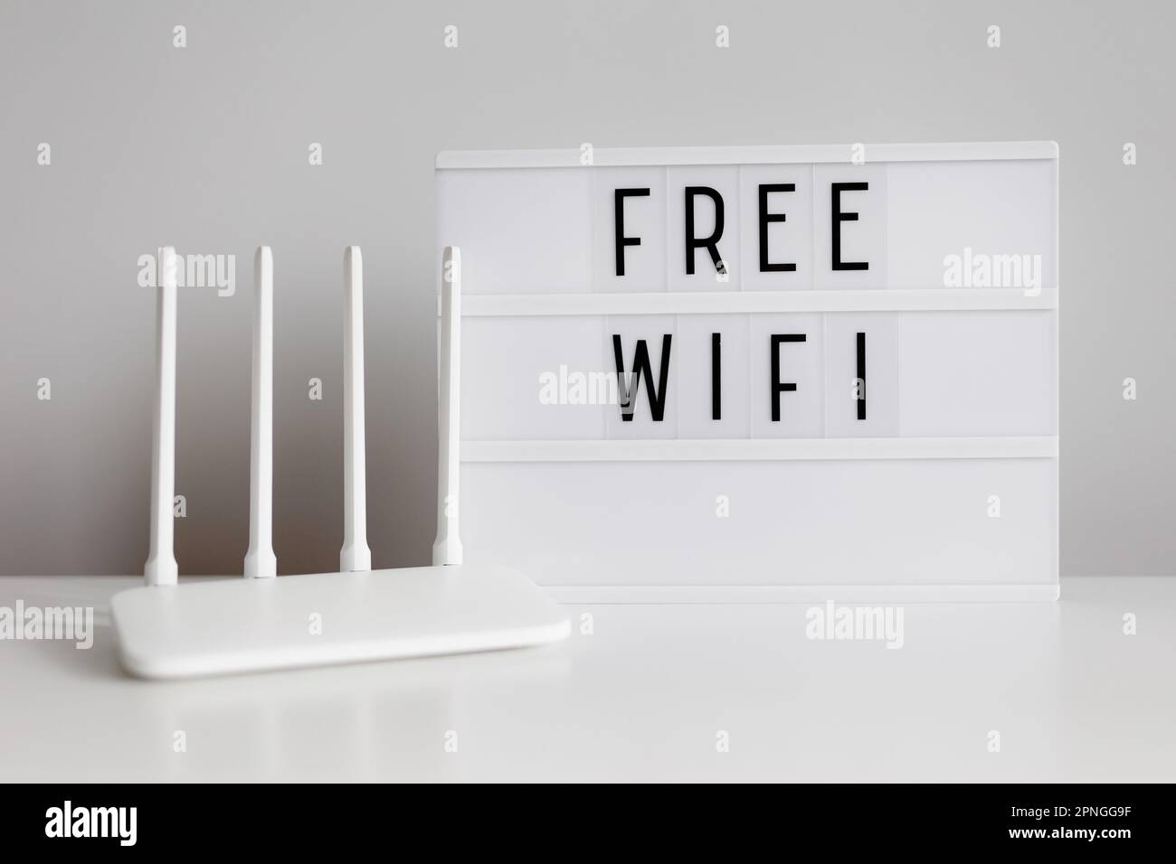 White router and lightbox with free wifi text Stock Photo - Alamy