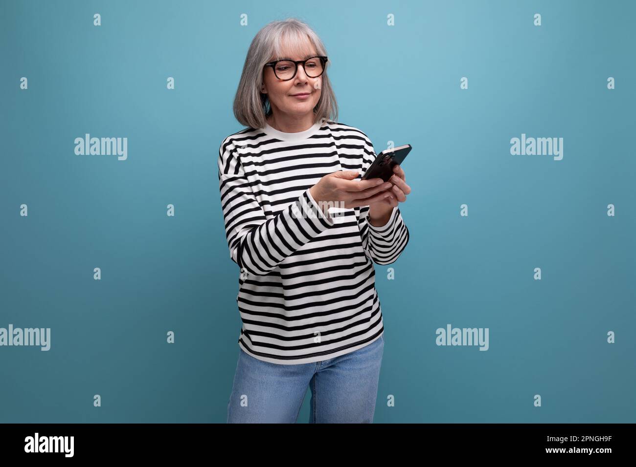middle aged business woman surfs the internet using smartphone on ...
