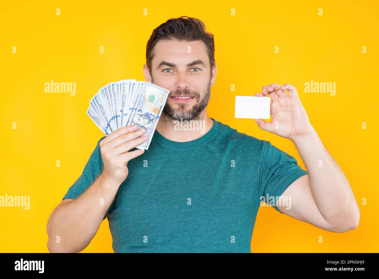 Man hold money on yellow studio isolated background. Portrait of rich ...